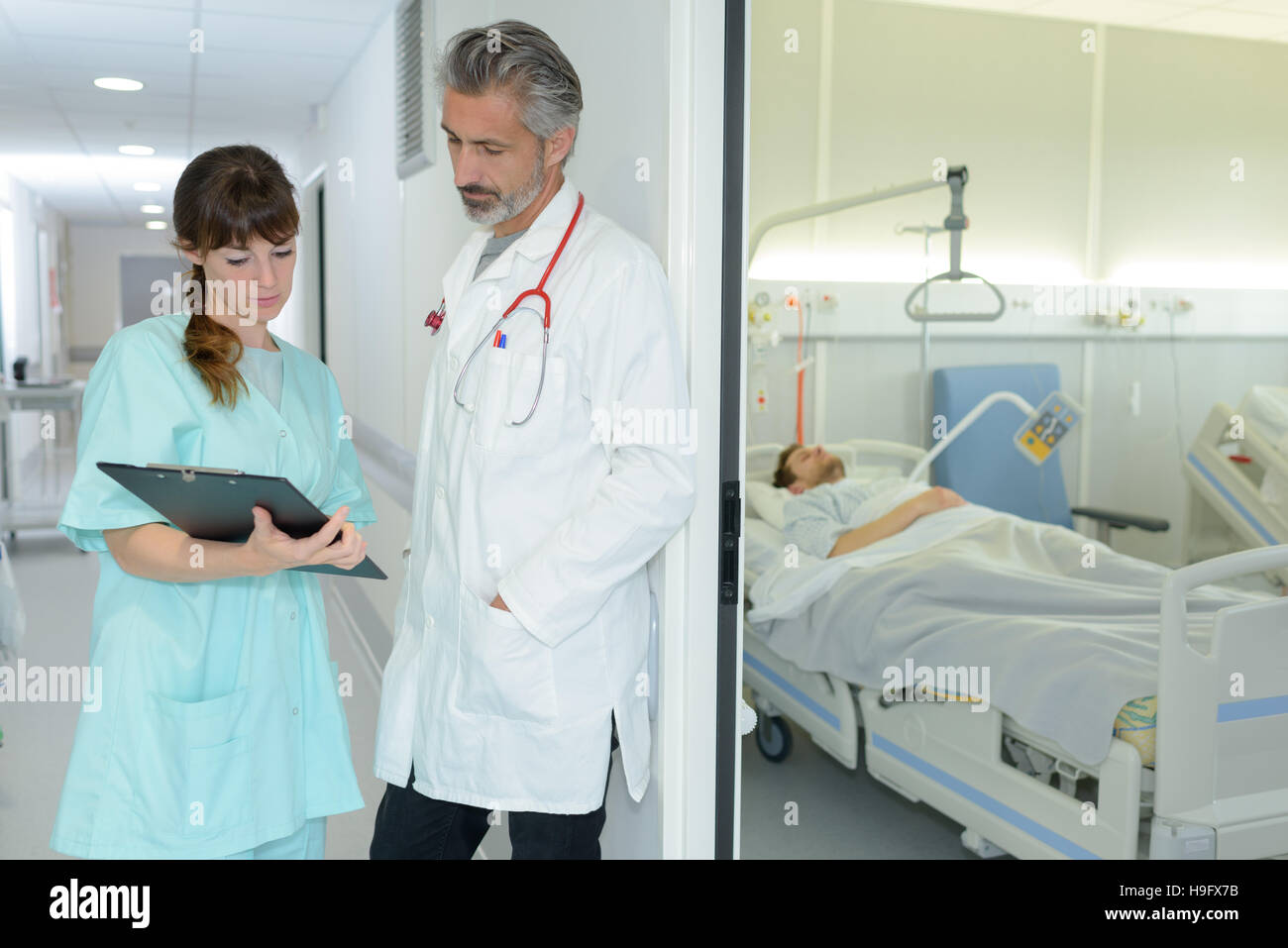 two sad worried doctors standing looking at patient results Stock Photo ...