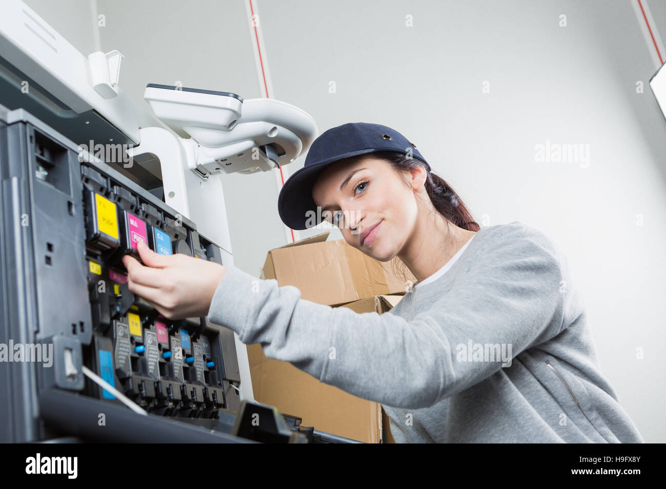 woman fixing cartridge in printer machine at office Stock Photo - Alamy