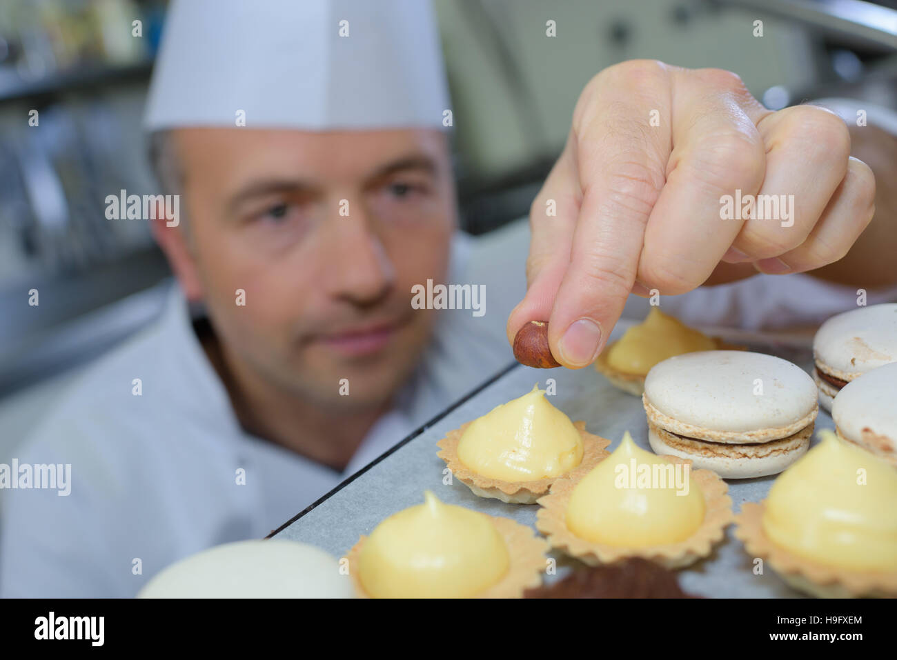 Confectionner garnishing cake Stock Photo - Alamy