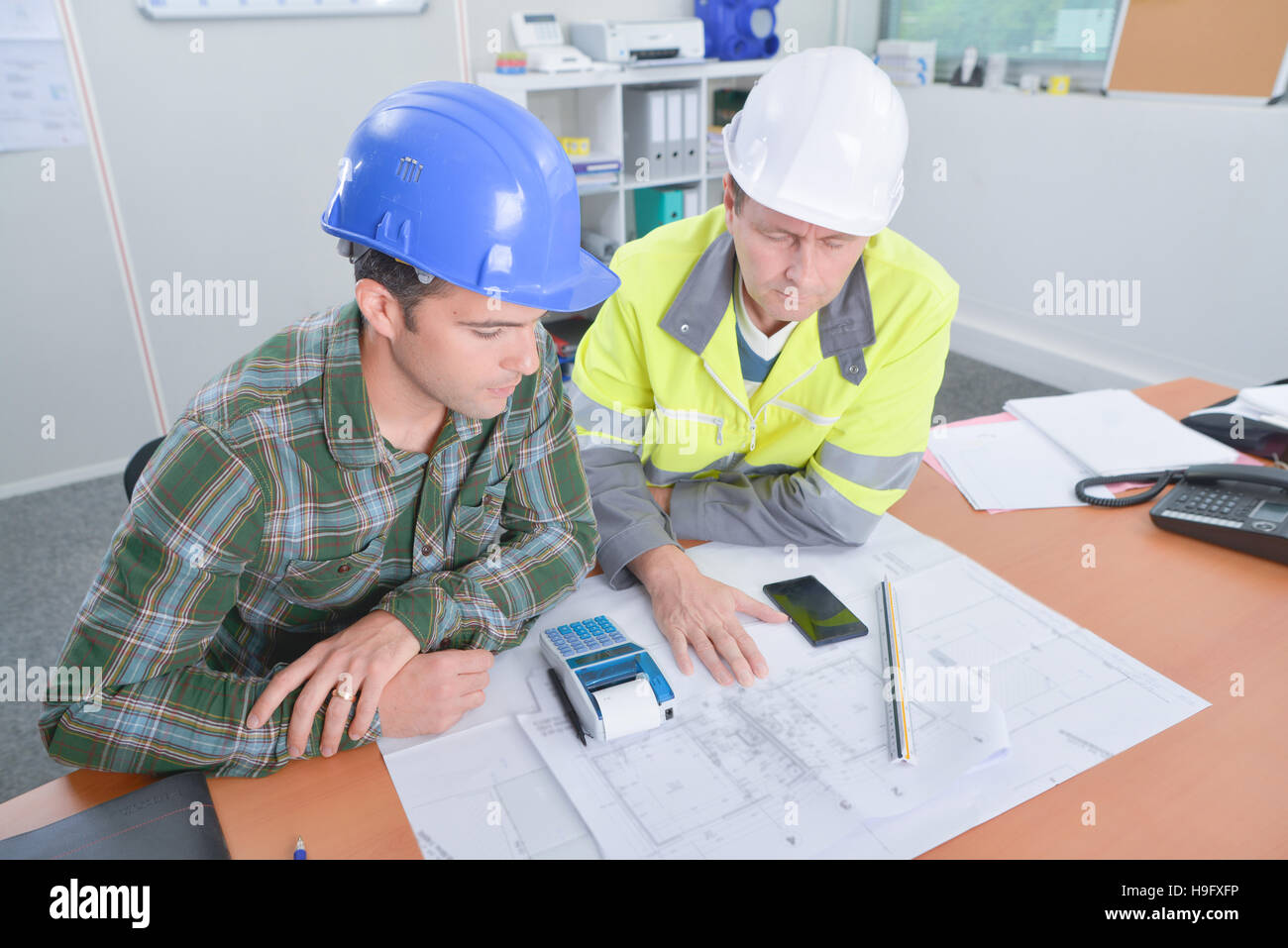 Architects crunching some numbers Stock Photo - Alamy