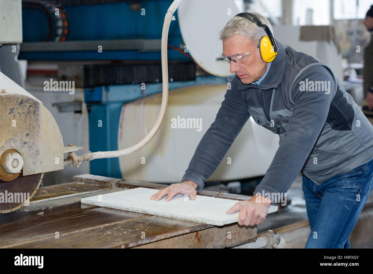 tile cutting worker working with floor tile cutting Stock Photo - Alamy