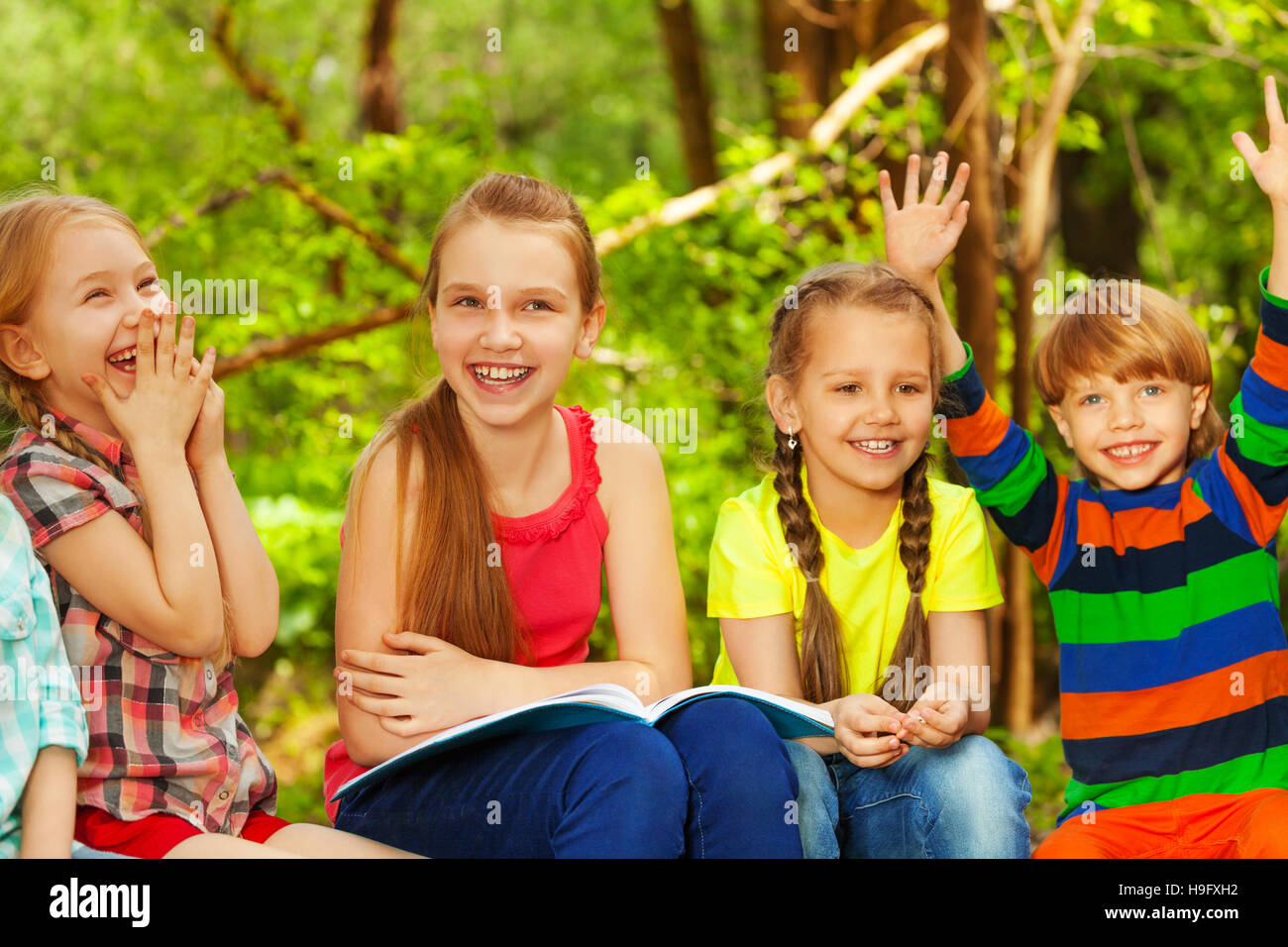 Four cute kids having fun in the summer forest Stock Photo - Alamy