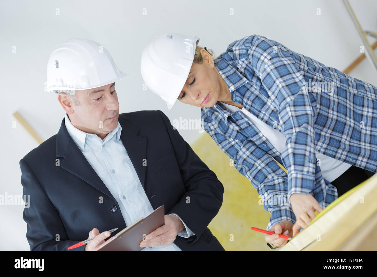 two carpenters making frame designs in their workshop Stock Photo - Alamy