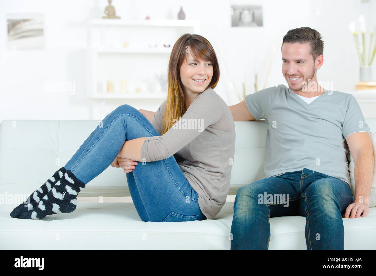 young happy couple on sofa Stock Photo - Alamy