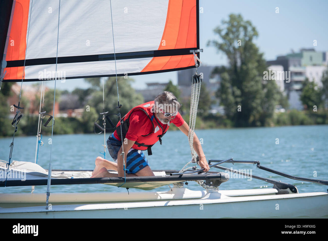 man on a saling boat Stock Photo - Alamy