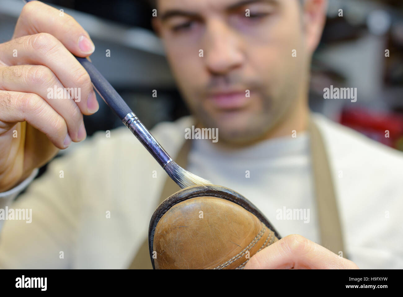 Cobbler repairing sole of shoe Stock Photo - Alamy