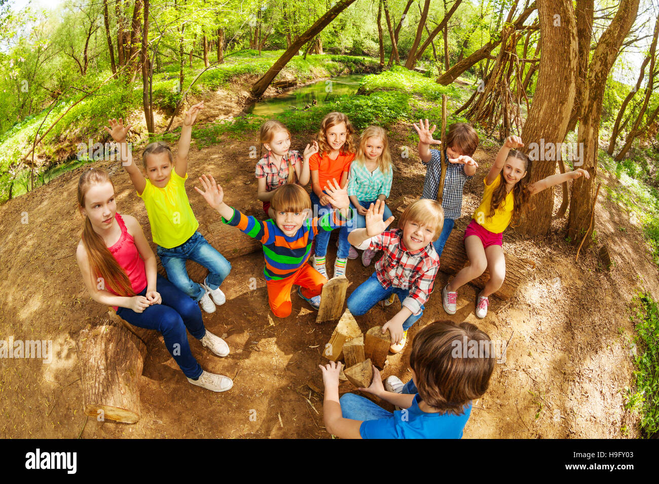 Cute kids having fun with their hands up in forest Stock Photo - Alamy