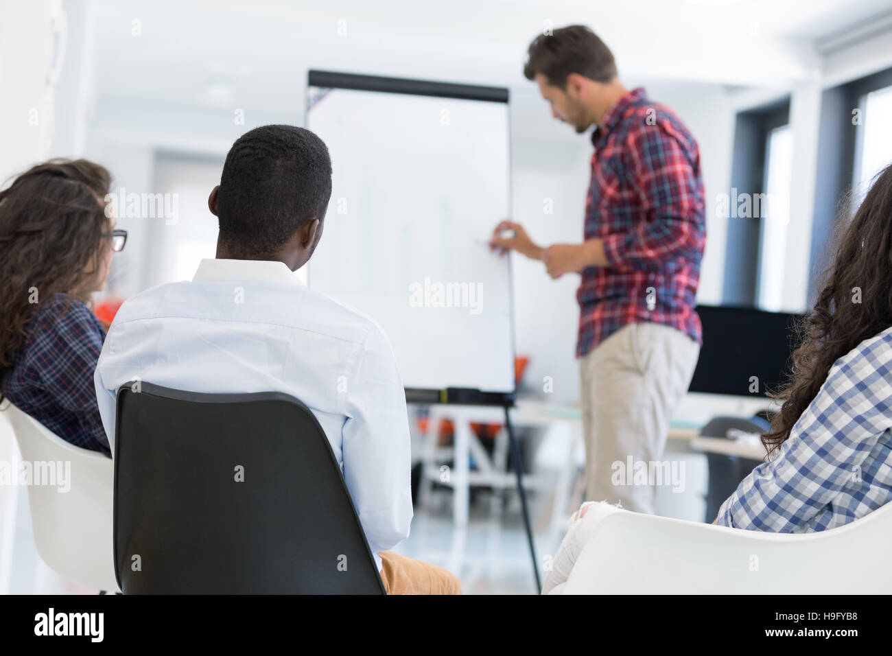 Businessman giving a presentation to his colleagues at work Stock Photo ...