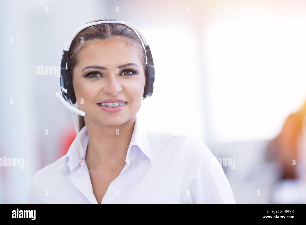 Female customer support operator with headset and smiling Stock Photo - Alamy