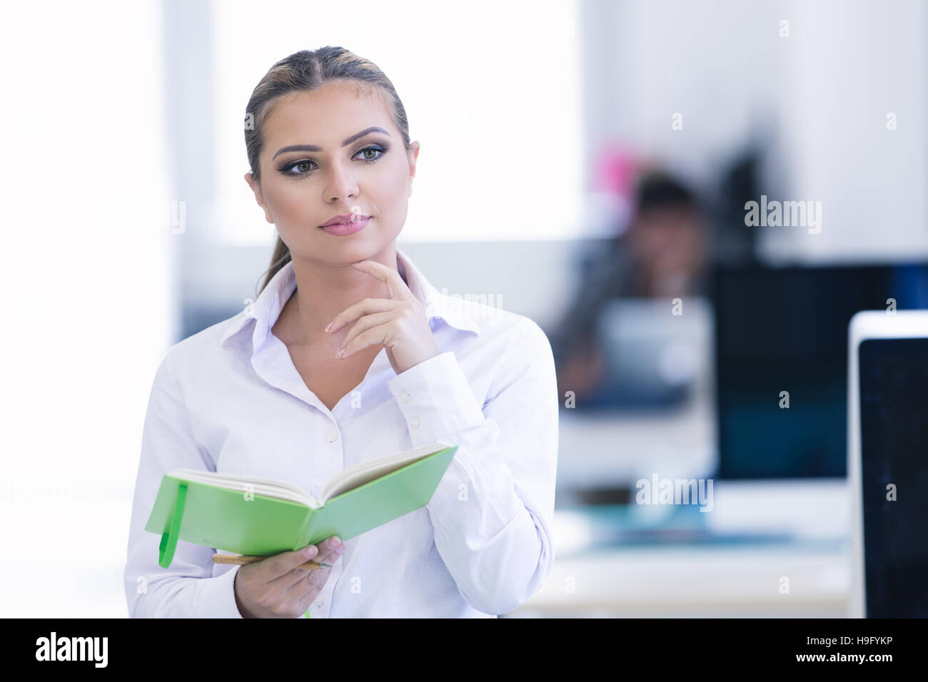 Portrait of busy secretary looking at camera Stock Photo - Alamy