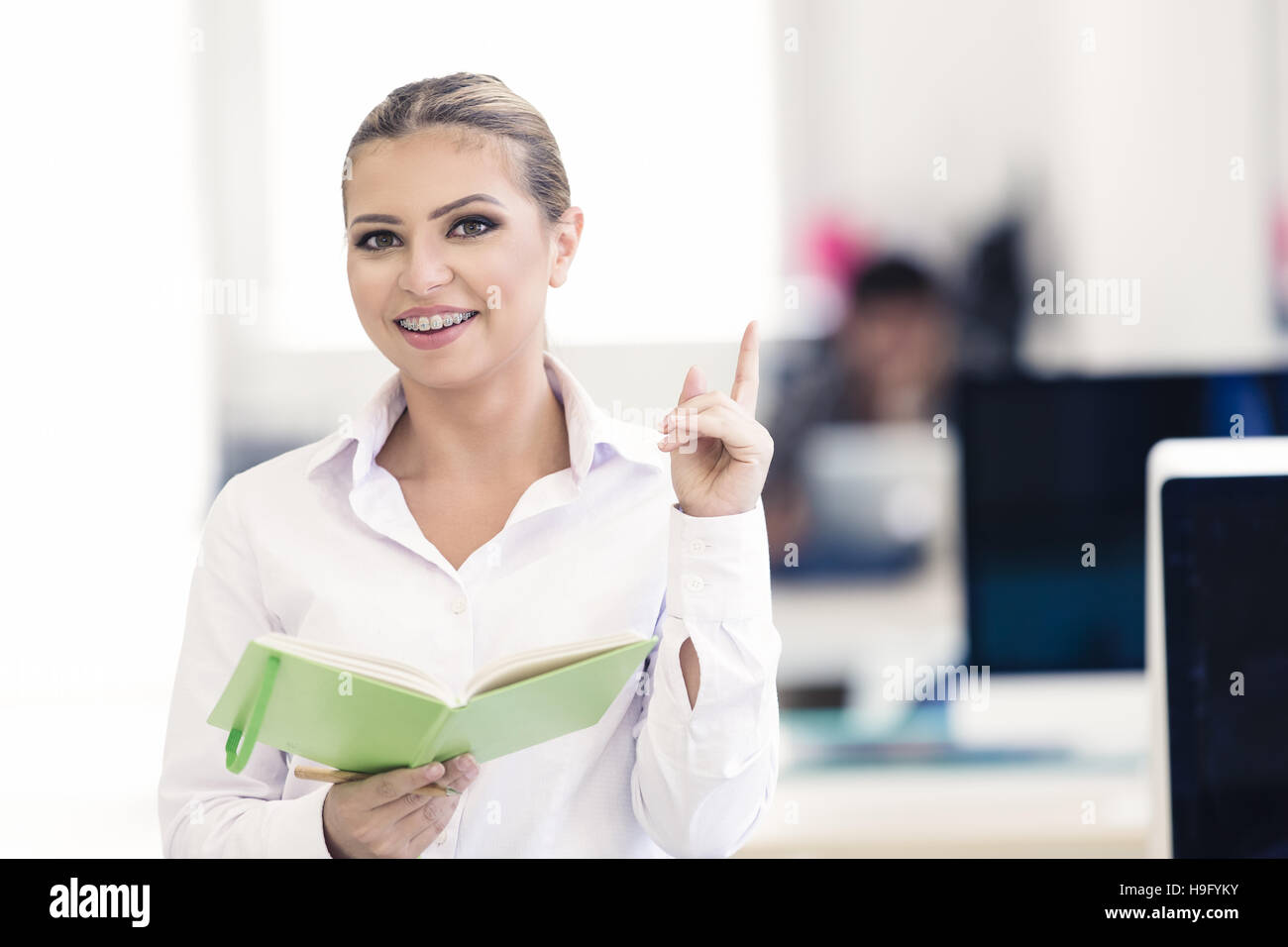 Portrait of busy secretary looking at camera Stock Photo - Alamy
