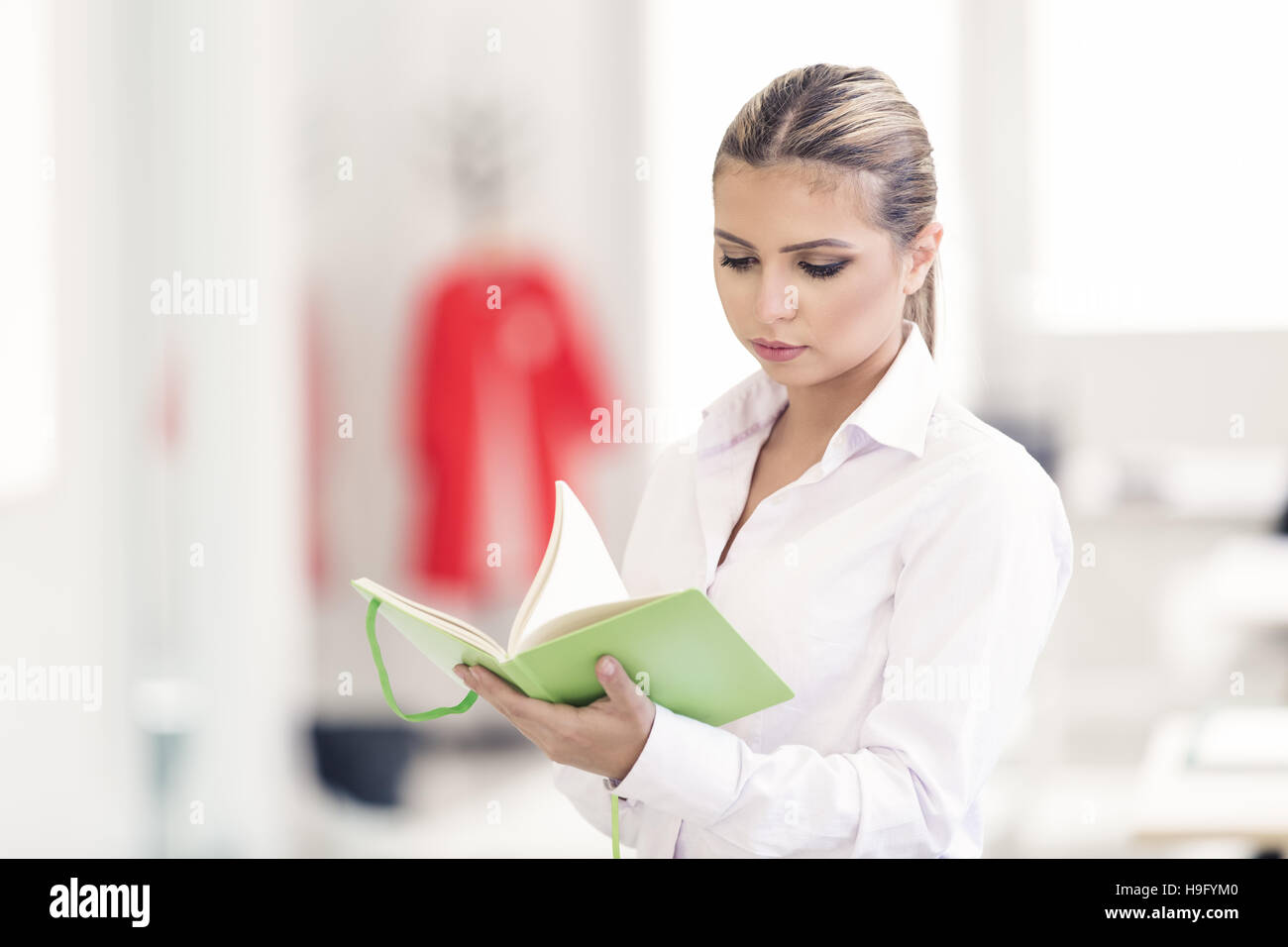 Portrait of busy secretary looking at camera Stock Photo - Alamy