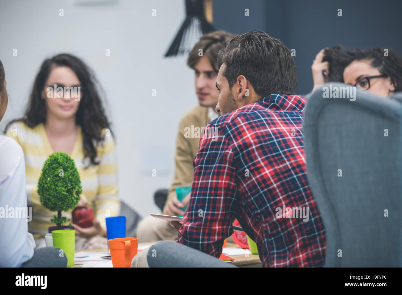 Group of young business professionals having a meeting Stock Photo - Alamy