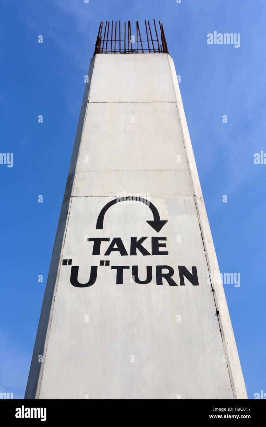 Take U Turn Traffic Sign on a pillar with sky background Stock Photo ...