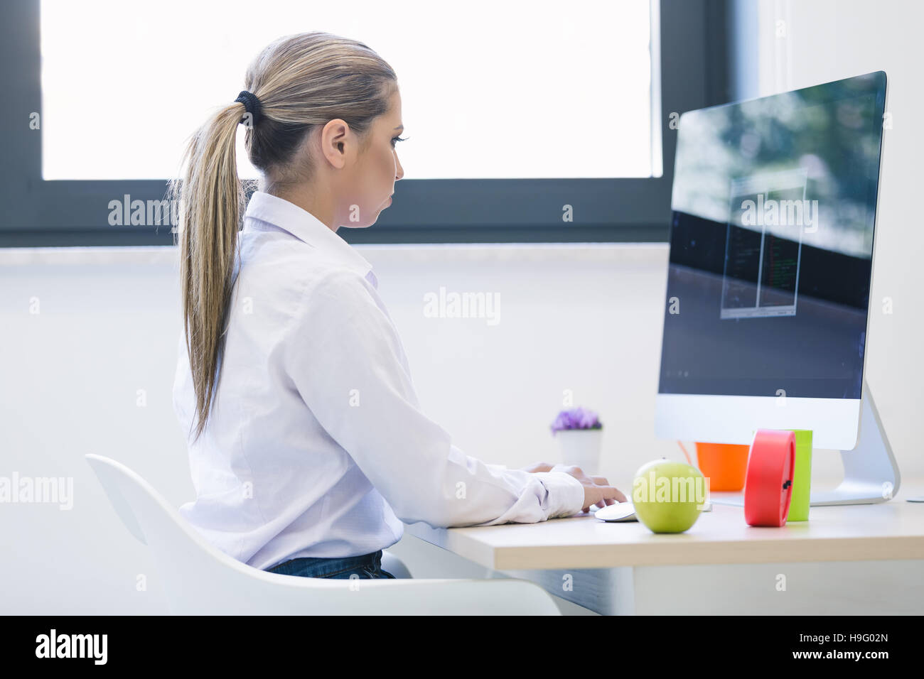 Woman working at computer in an office Stock Photo - Alamy