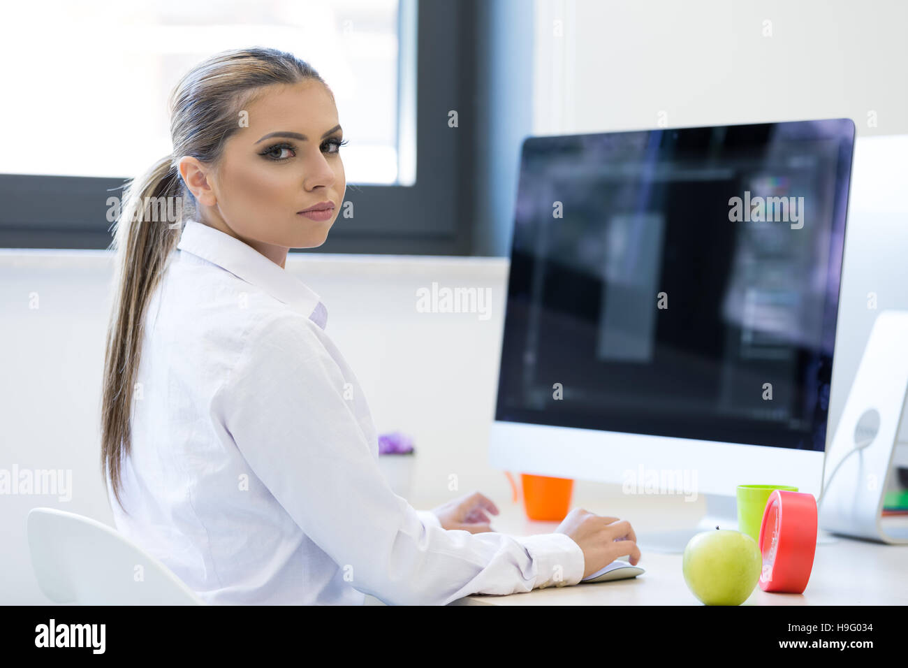 Woman working at computer in an office Stock Photo - Alamy