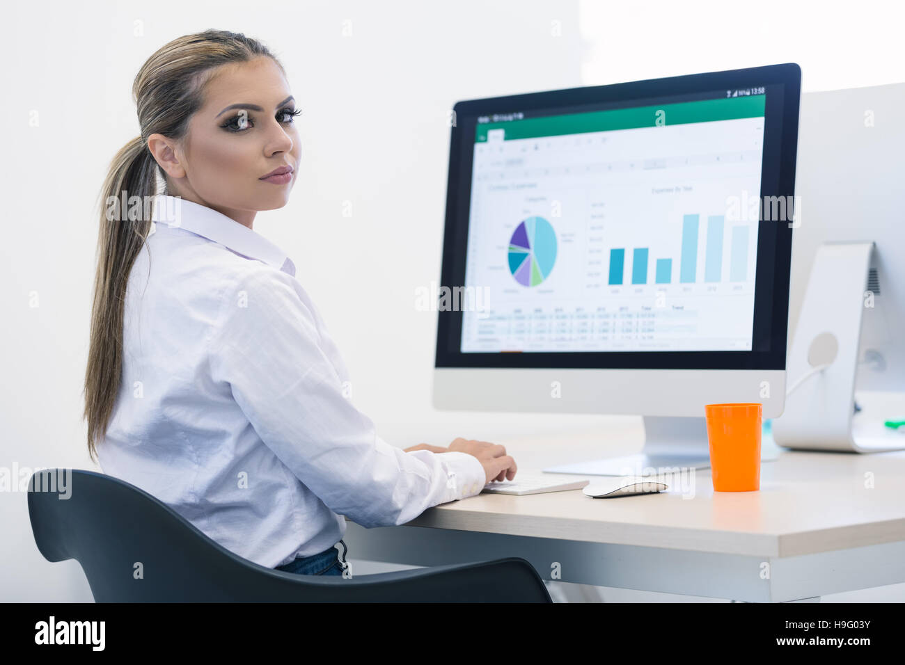 Woman working at computer in an office Stock Photo - Alamy