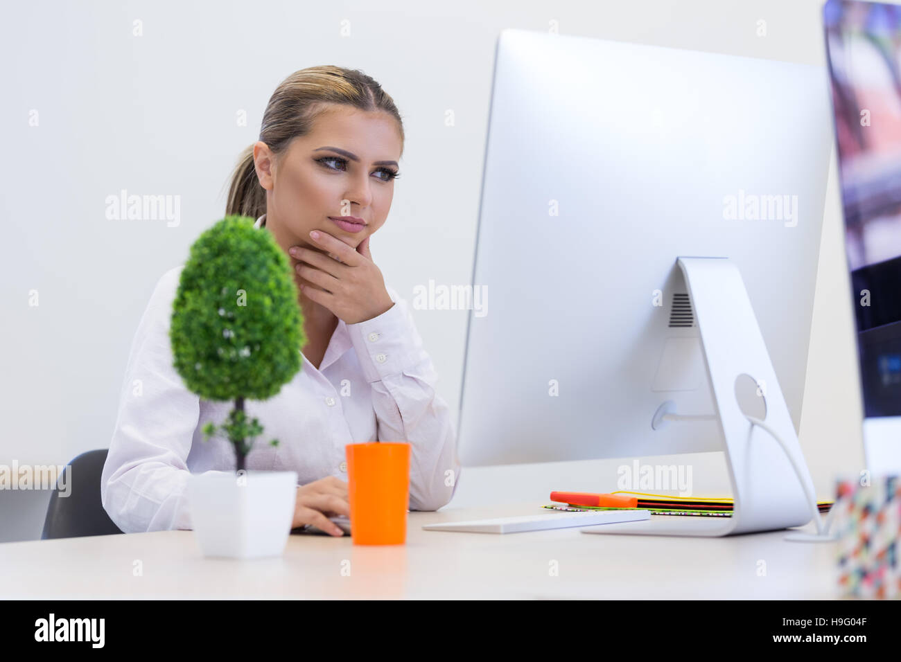 Woman working at computer in an office Stock Photo - Alamy