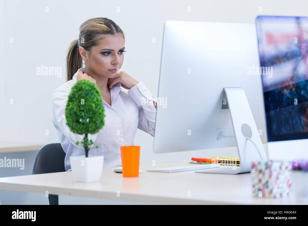 Woman working at computer in an office Stock Photo - Alamy