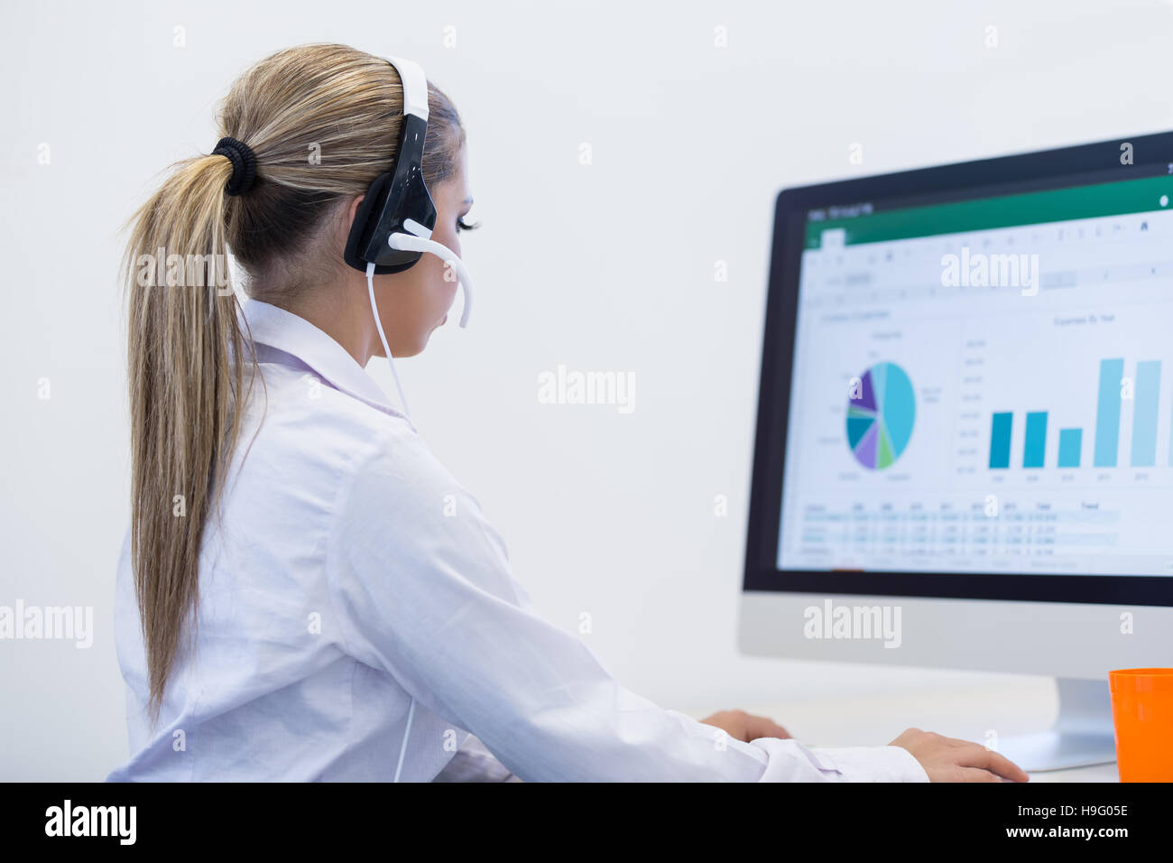 Woman working at computer in an office Stock Photo - Alamy