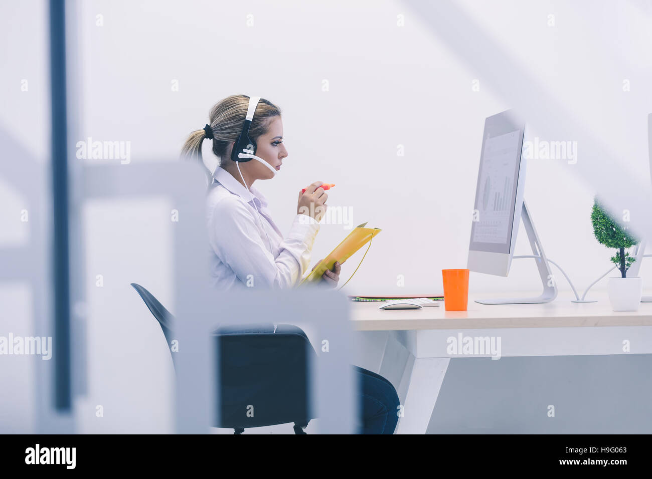 Woman working at computer in an office Stock Photo - Alamy