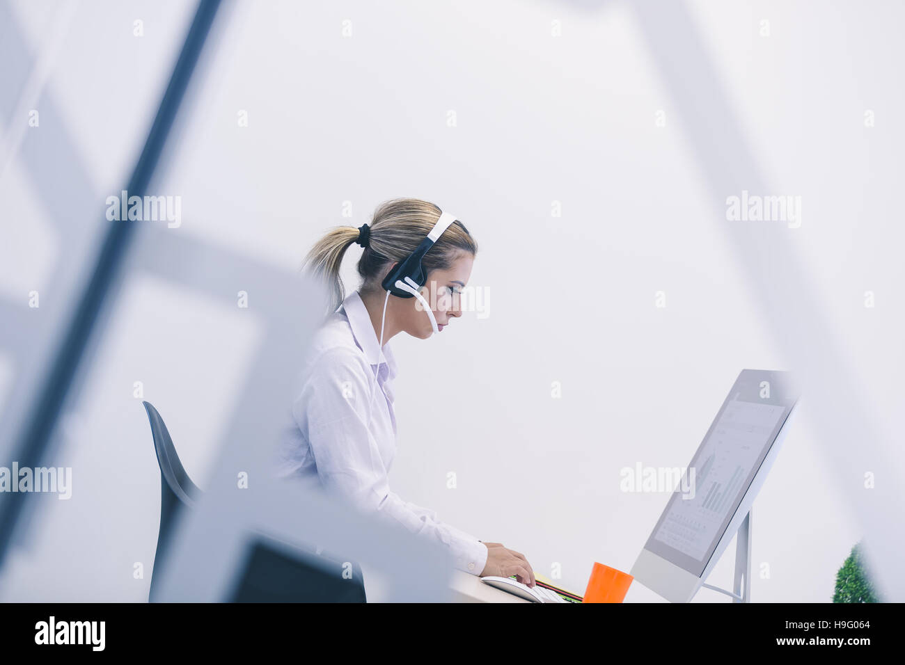 Woman working at computer in an office Stock Photo - Alamy