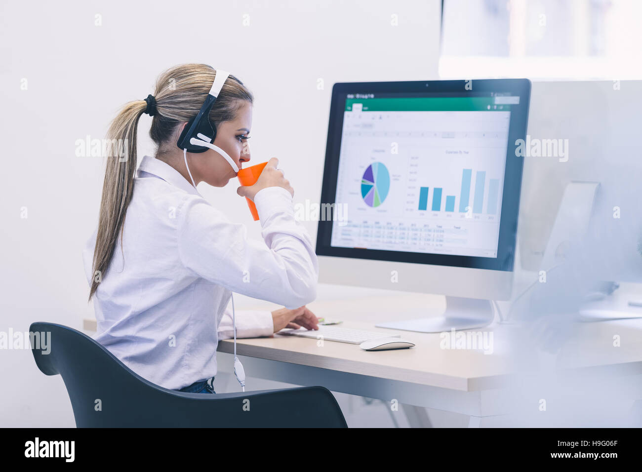 Woman working at computer in an office Stock Photo - Alamy