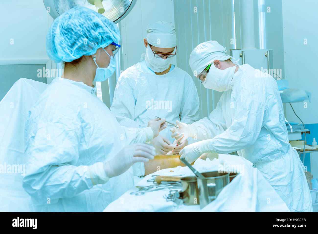 Doctors operate on a patient Stock Photo - Alamy