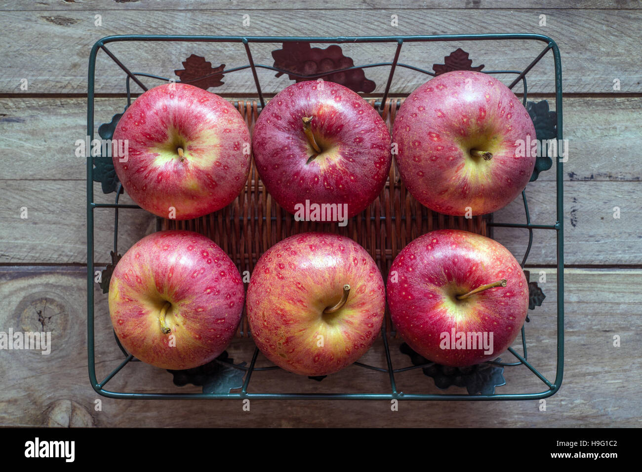 Tray with red apples on wooden table Stock Photo - Alamy