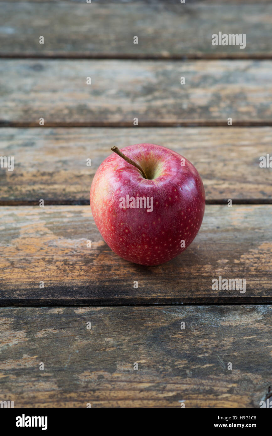 A red apple on rustic wood. Copy space Stock Photo - Alamy