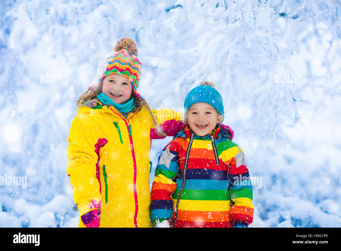 Little girl and boy enjoying sleigh ride. Child sledding. Toddler kid ...