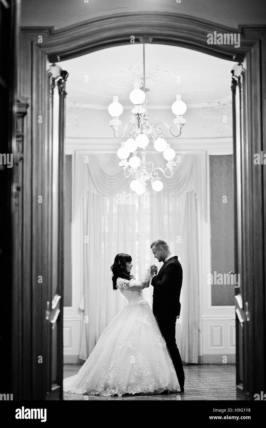 Rich wedding couple at royal room with golden lamp on the ceiling Stock ...