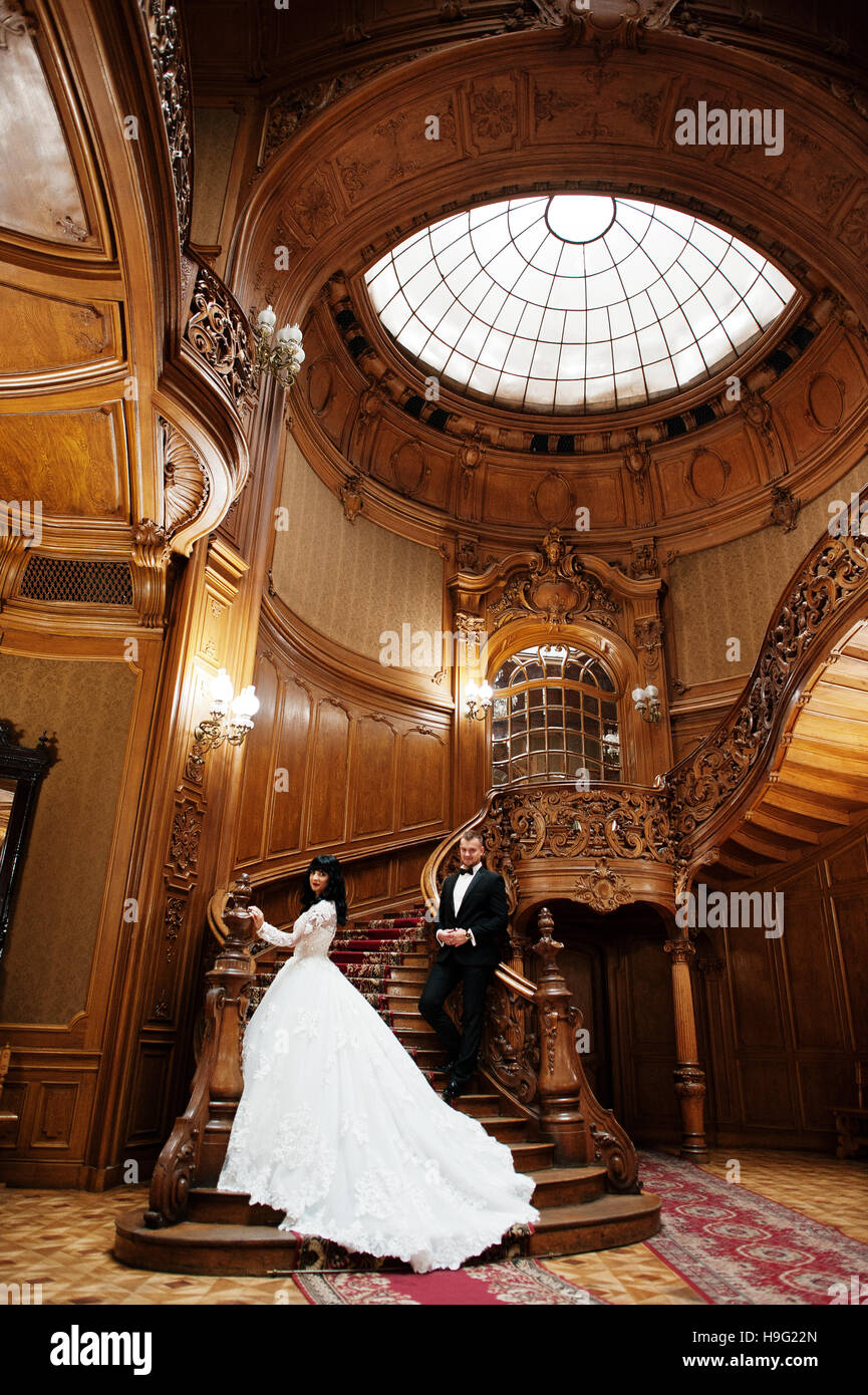 Amazing wedding couple on big wooden stairs at rich palace Stock Photo ...
