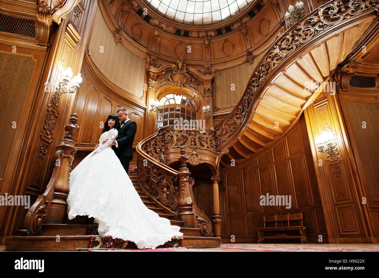 Amazing wedding couple on big wooden stairs at rich palace Stock Photo ...