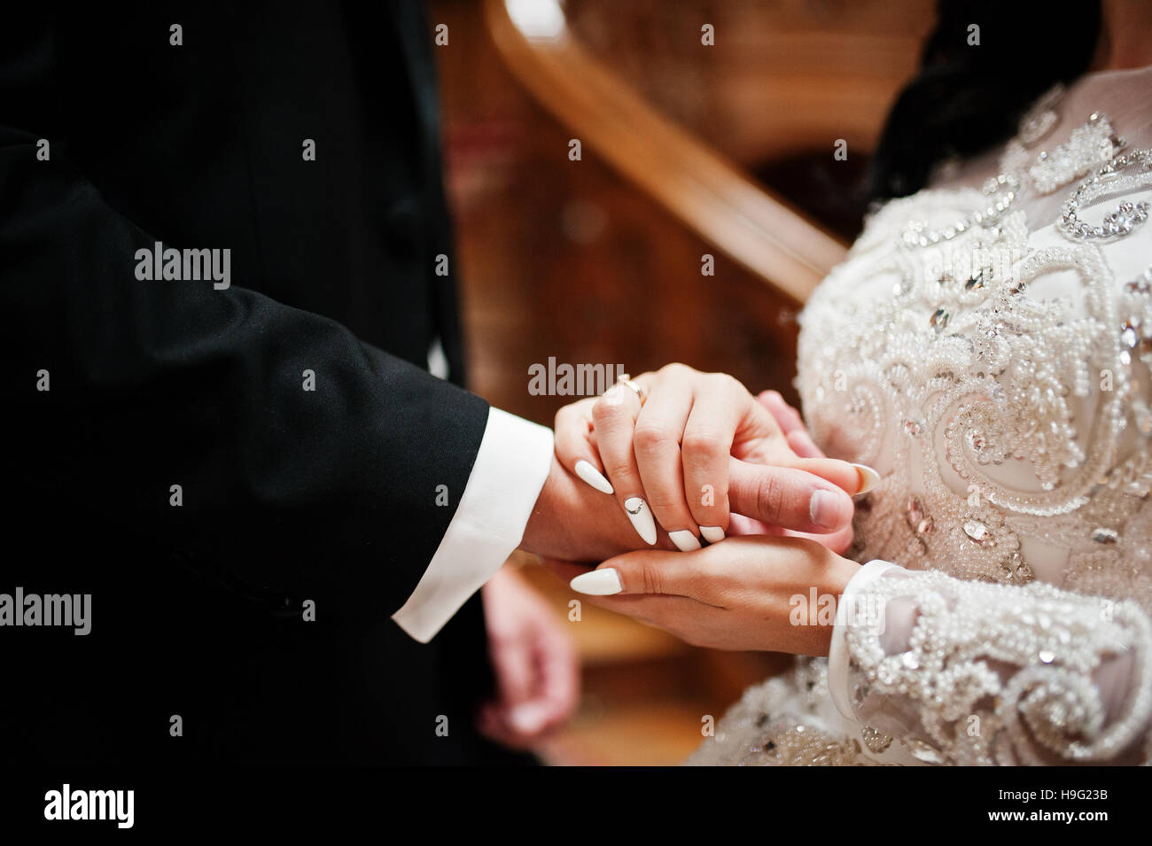 Closeup hand in hand of wedding couple indoor Stock Photo - Alamy