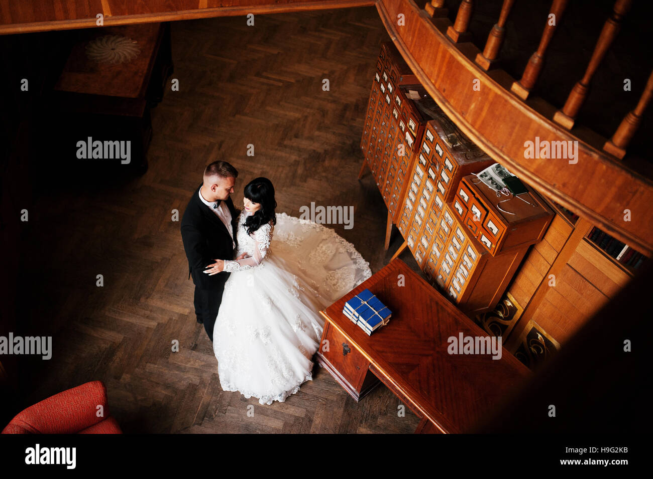 Wedding couple on old wooden library at their wedding day Stock Photo ...