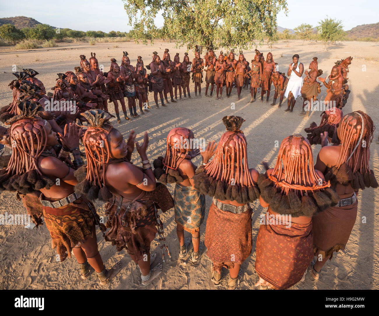 Women from Himba people in traditional clothes and haircuts are ...