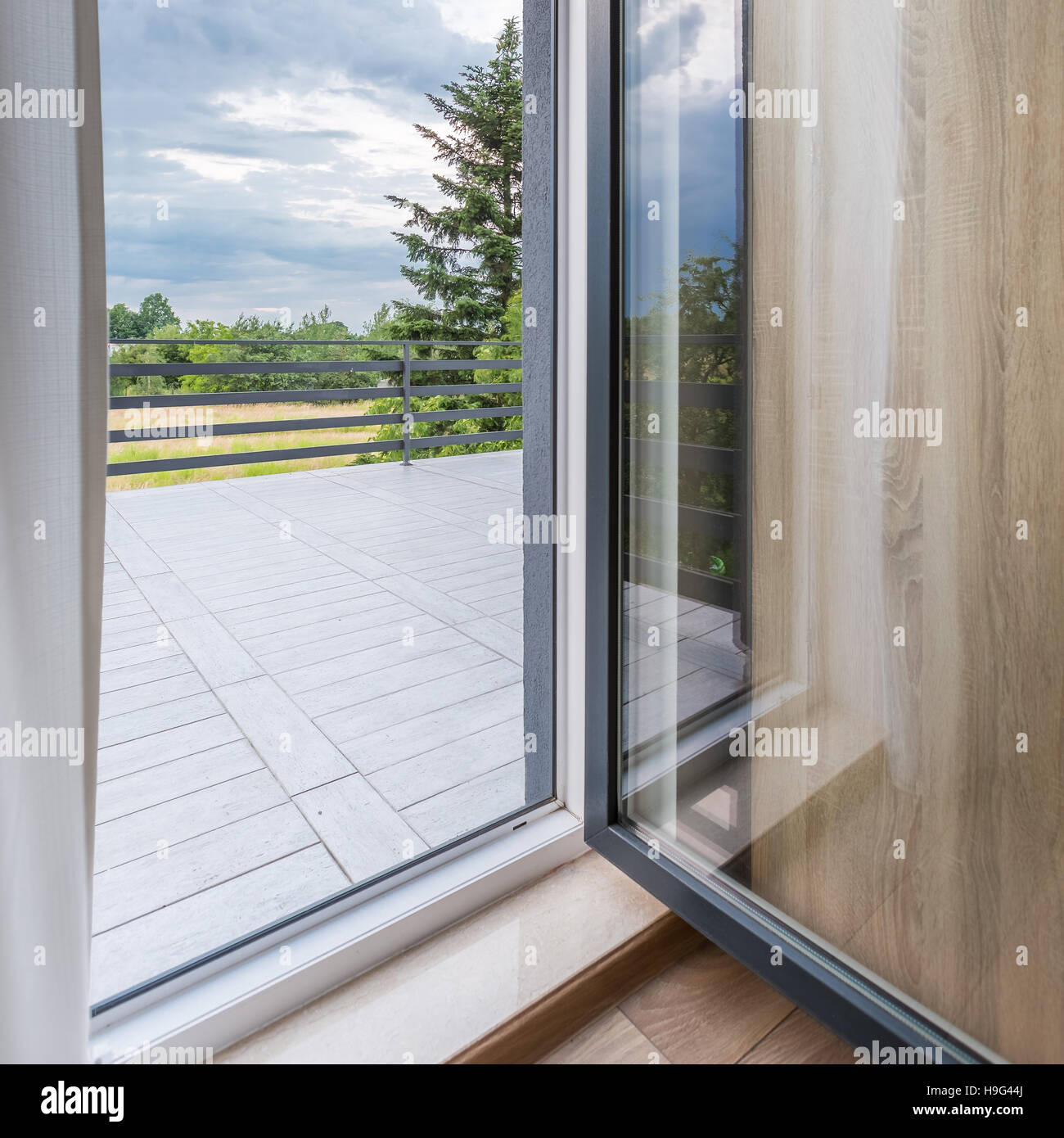 Open balcony doors, large balcony with stylish flooring, simple ...