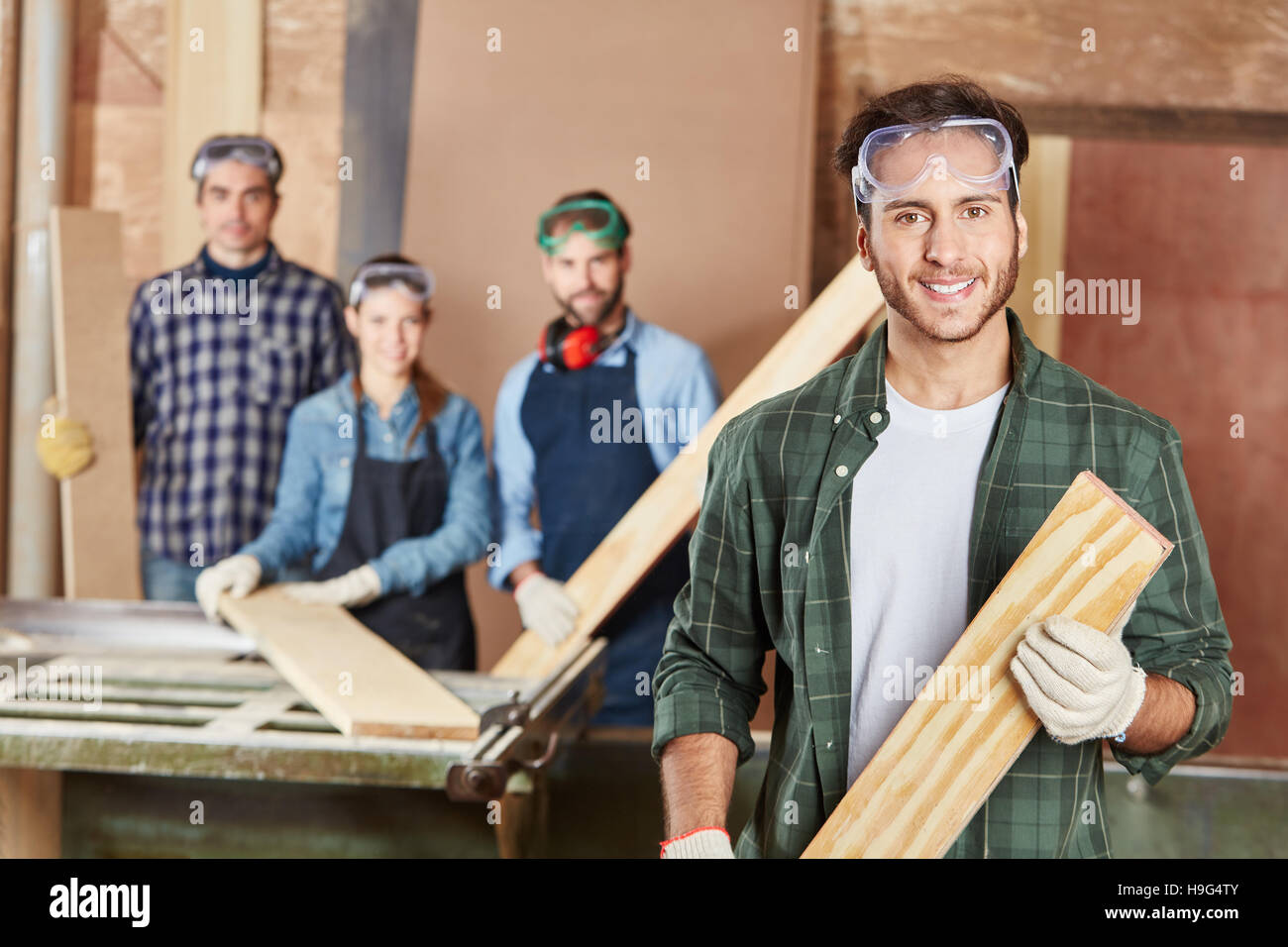 Man as carpenter with wood on his hands Stock Photo - Alamy