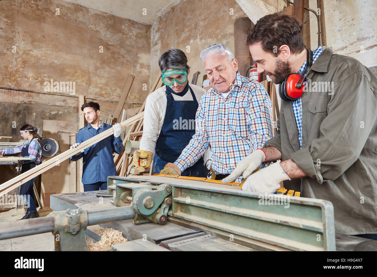 Carpenter trainees learning with boss about wood measurement Stock ...