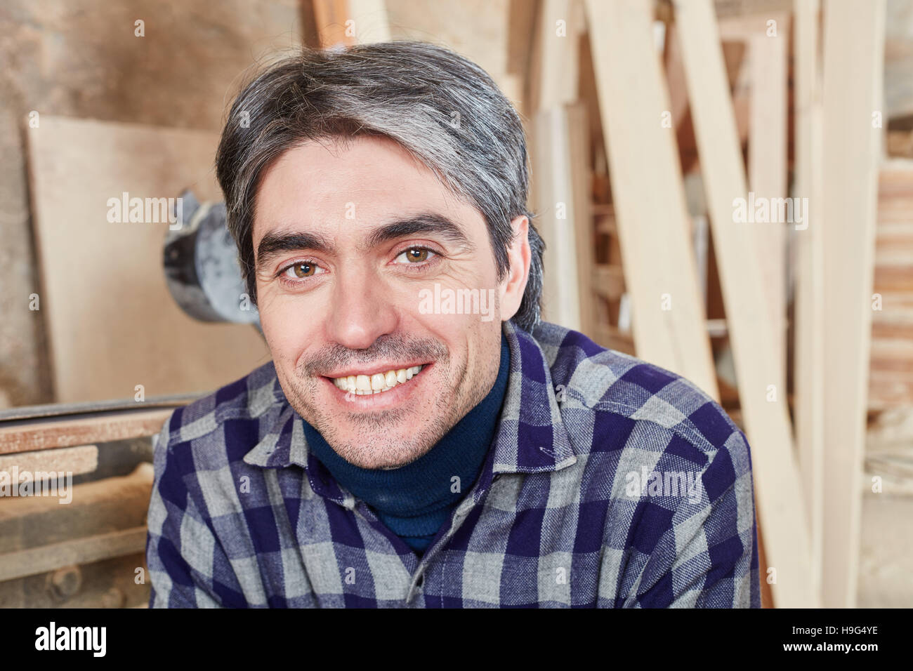 Portrait of content man as craftsman at workshop Stock Photo - Alamy