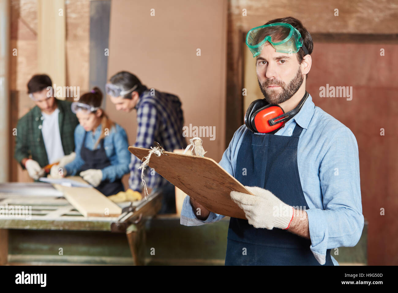 Carpenter with checklist during organization and planning Stock Photo ...