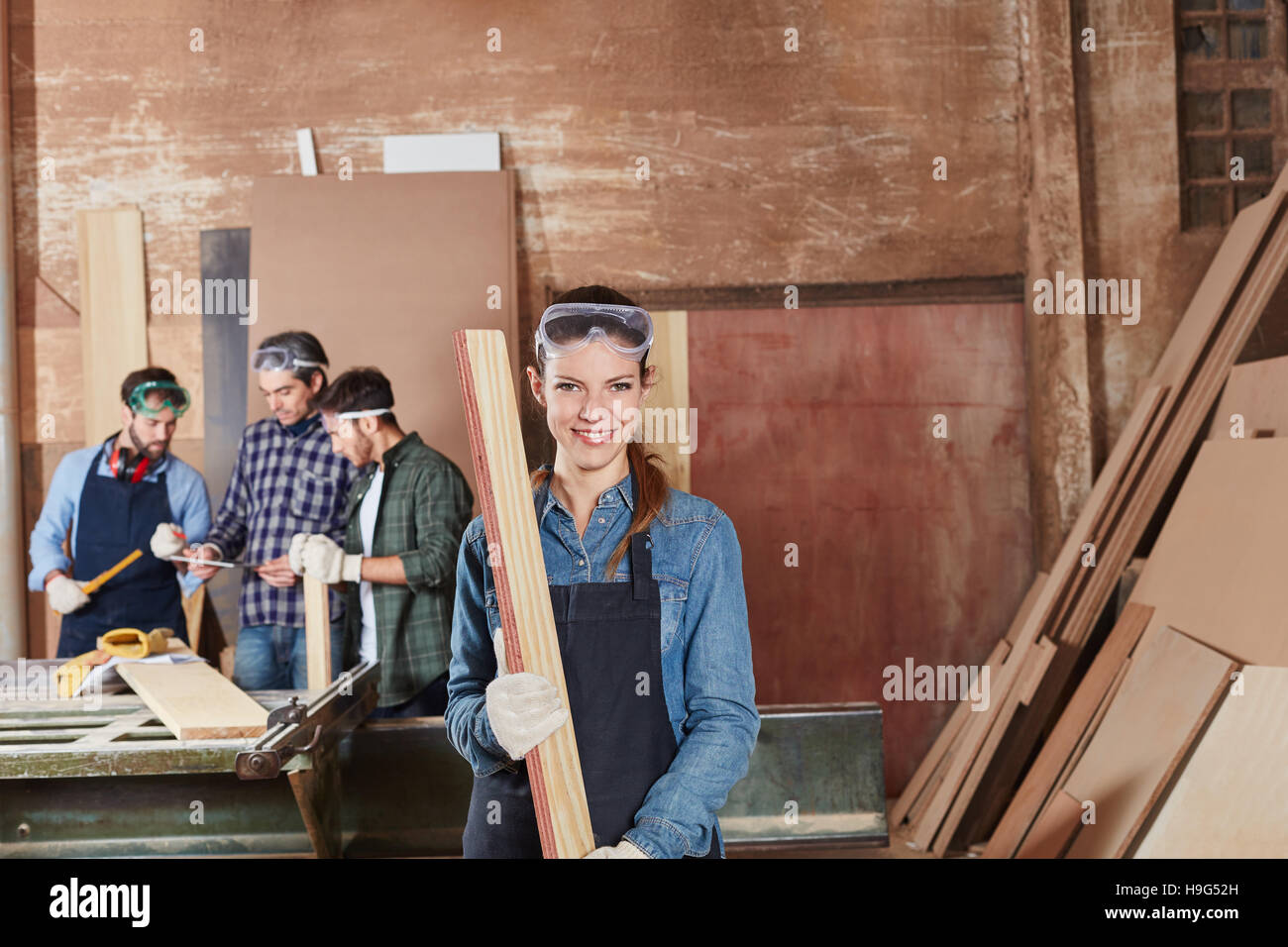 Woman as carpentry apprentice working with wood Stock Photo - Alamy