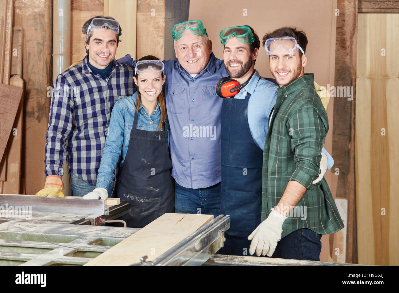 Team standing together during their apprenticeship Stock Photo - Alamy