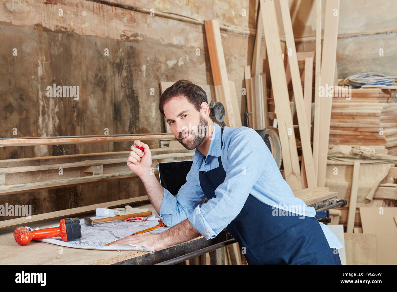 Craftsman working on floorplan at workshop Stock Photo - Alamy