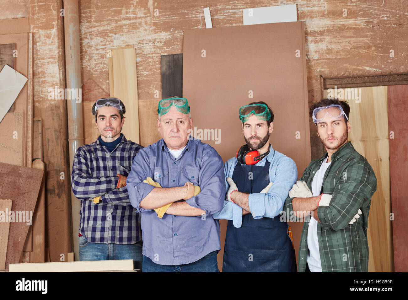 Craftsman team with arms crossed looking confident Stock Photo - Alamy