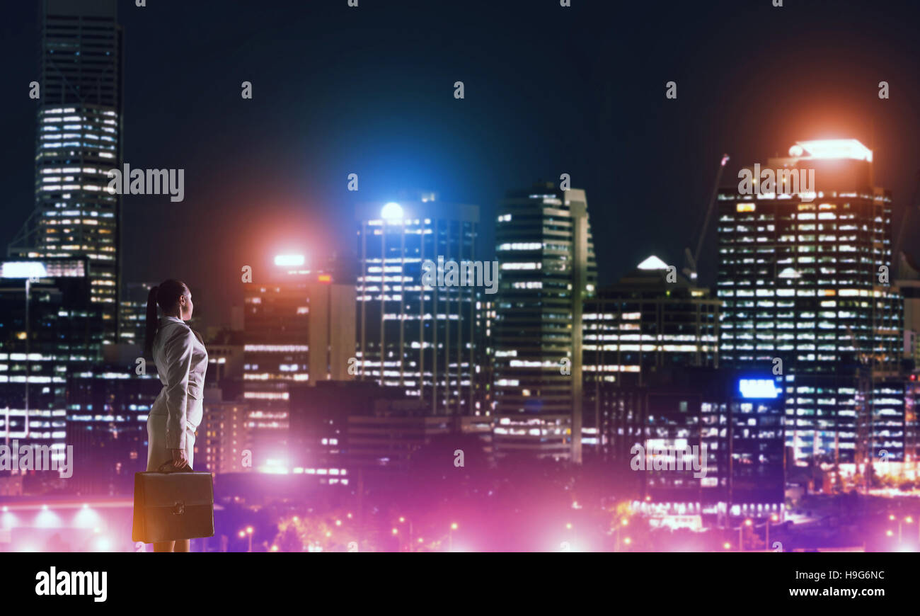 Woman looking at night city Stock Photo - Alamy