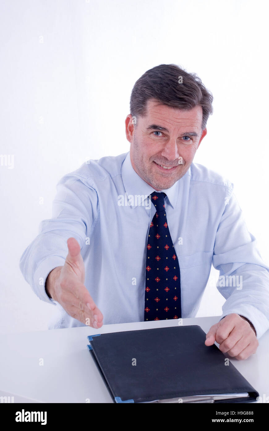 Businessman smiles looks hand hi-res stock photography and images - Alamy
