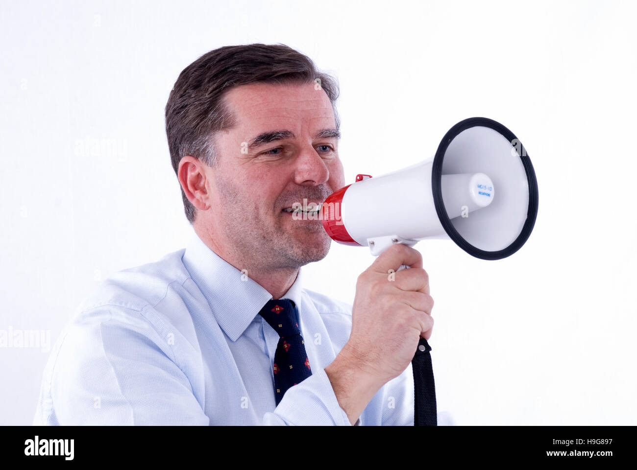 Businessman, 50+, using a megaphone Stock Photo - Alamy