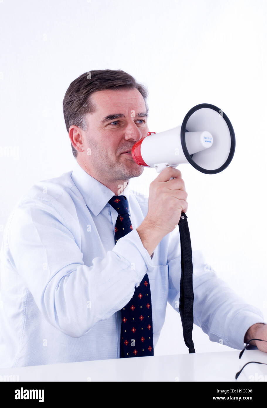 Businessman, 50+, using a megaphone Stock Photo - Alamy